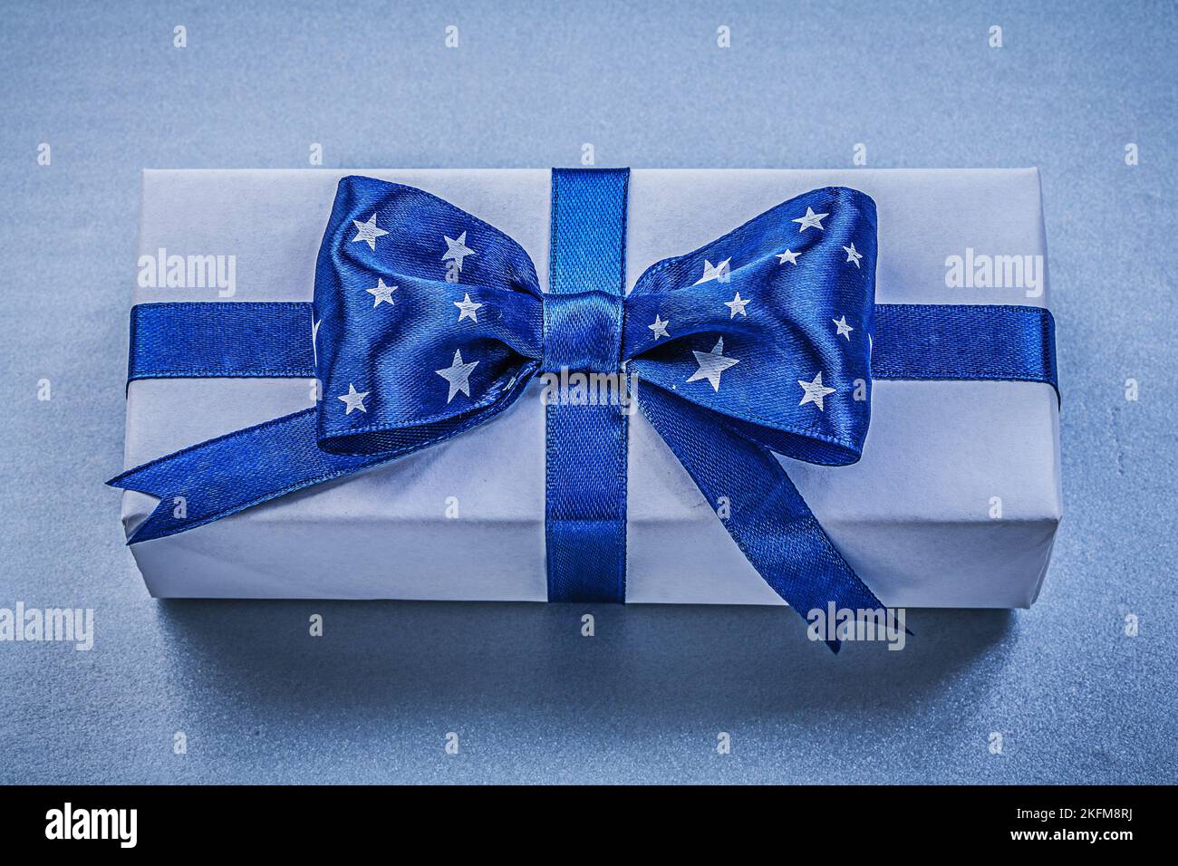 Packed gift box on blue background holidays concept Stock Photo - Alamy