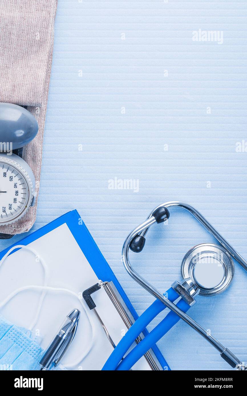 organized copyspace clipboard with white blank paper masks pen ...