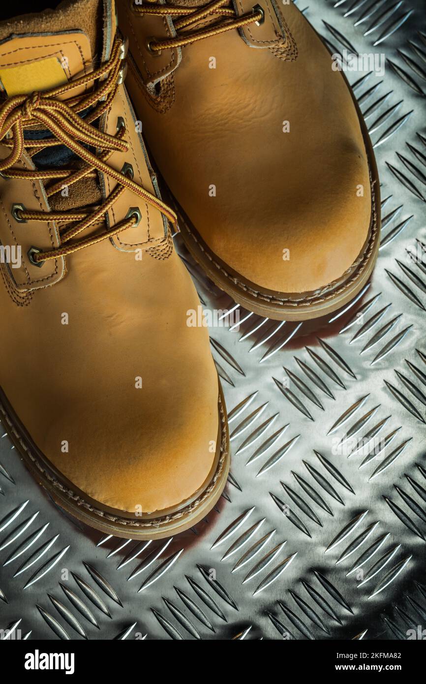 Pair of leather protective boots on fluted metal sheet Stock Photo - Alamy