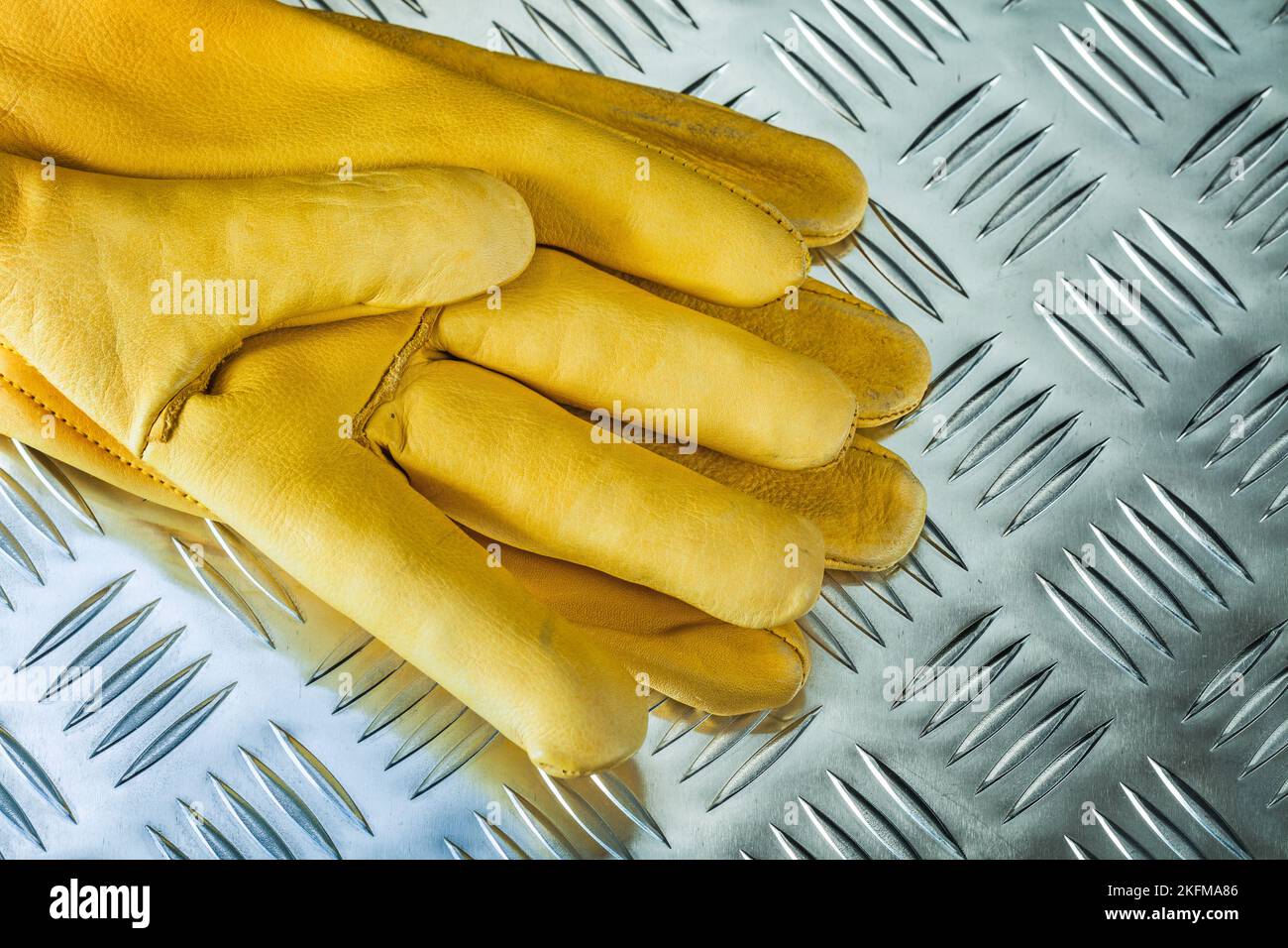 Pair of leather protective gloves on corrugated metal texture Stock ...