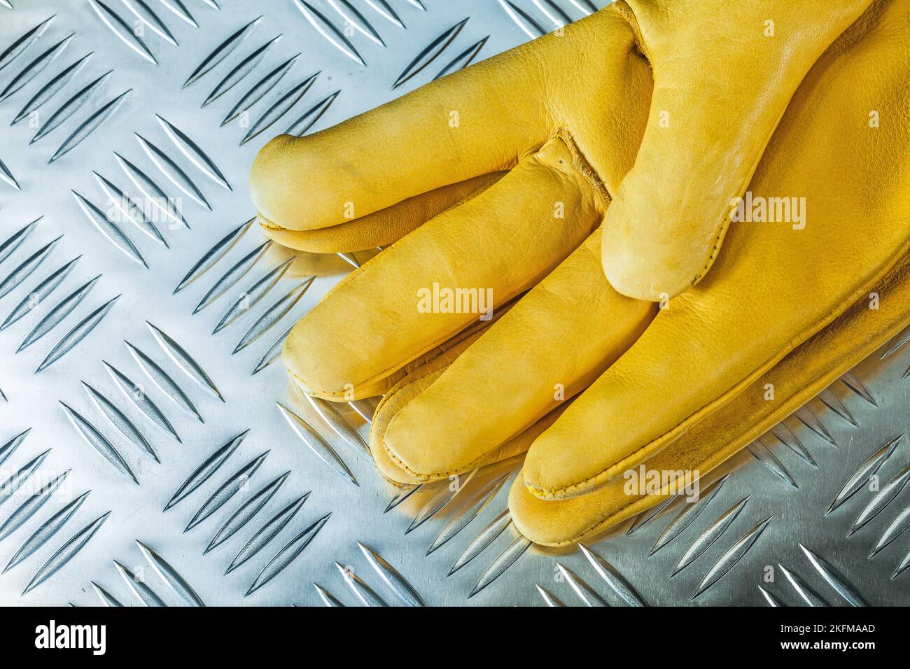 Pair of leather safety gloves on corrugated metal texture Stock Photo ...