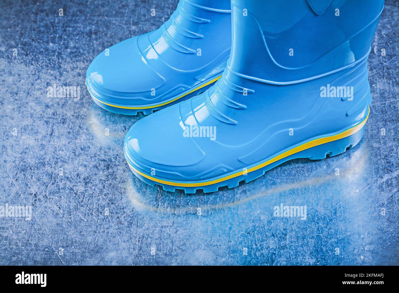 Pair of safety gumboots on metallic background Stock Photo - Alamy