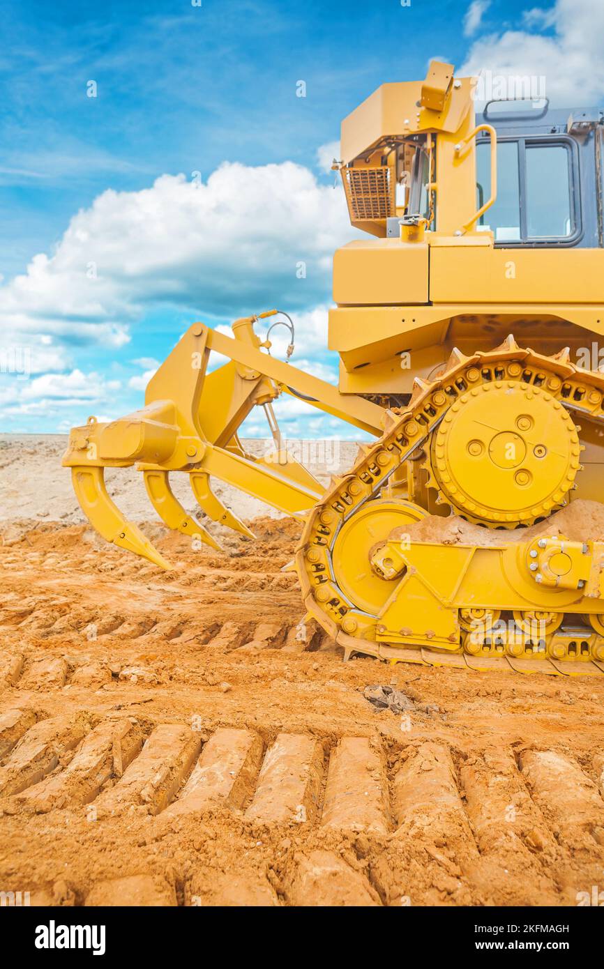 part of bulldozer standing on sand at construction site rear view with ...