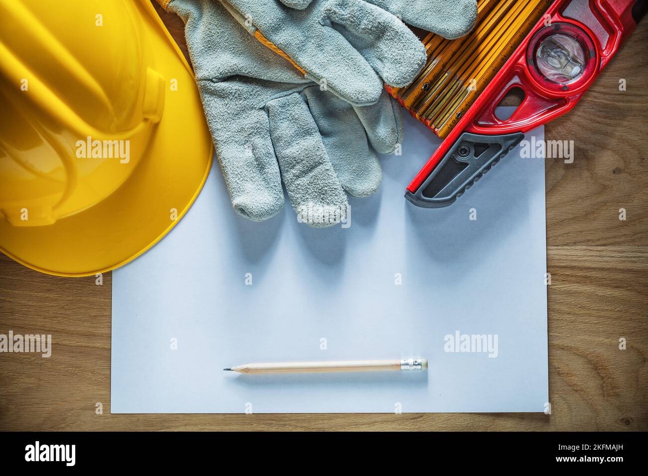Pencil paper safety gloves wooden meter construction level hard hat on ...