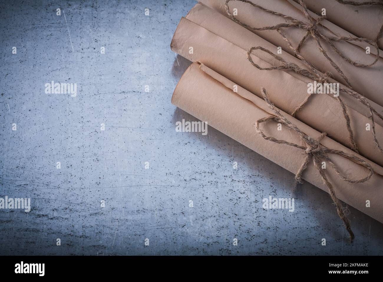 Pile of vintage paper rolls on scratched metallic surface Stock Photo ...
