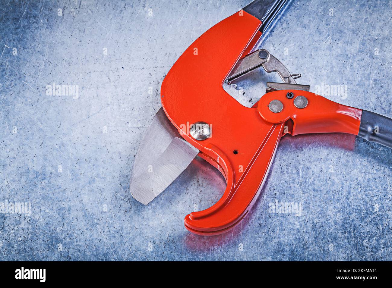 Pipe cutter on scratched metallic background top view construction ...
