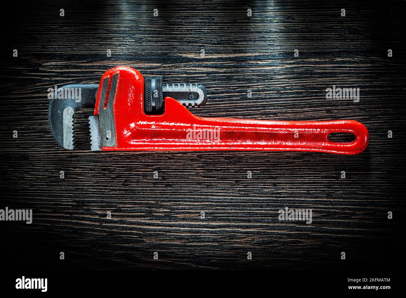 Pipe wrench on vintage wooden board Stock Photo - Alamy