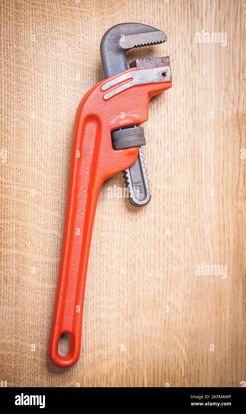 pipe wrench on wooden board Stock Photo - Alamy