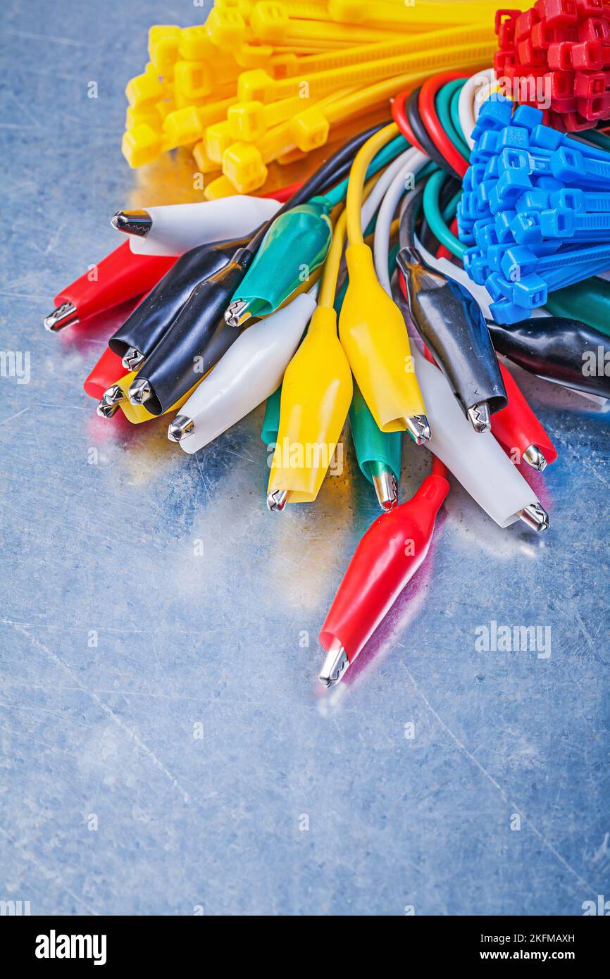 Plastic cable ties electric crocodile plugs on scratched metallic ...