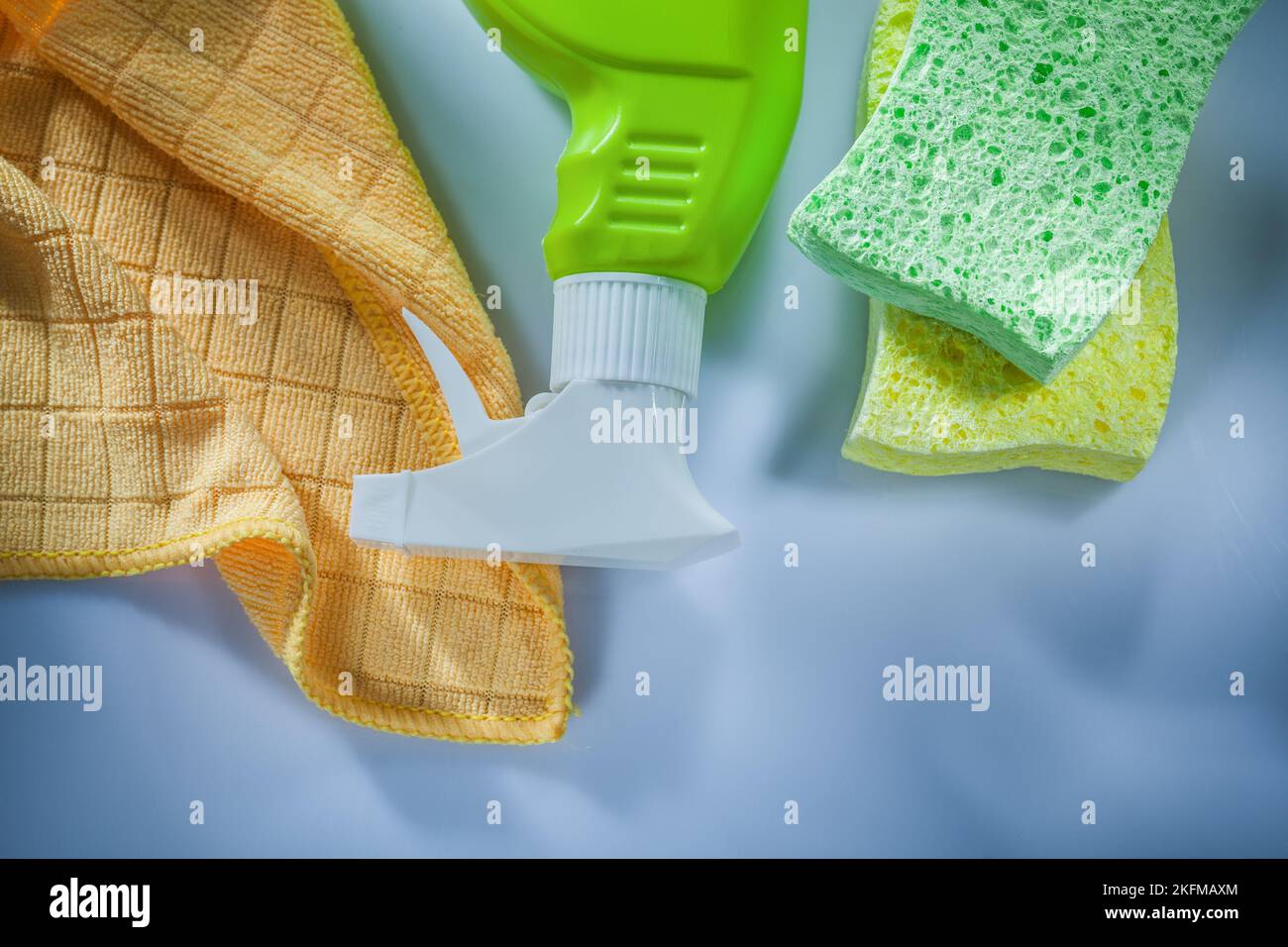 Plastic sprayer washing sponge cloth on white surface Stock Photo - Alamy