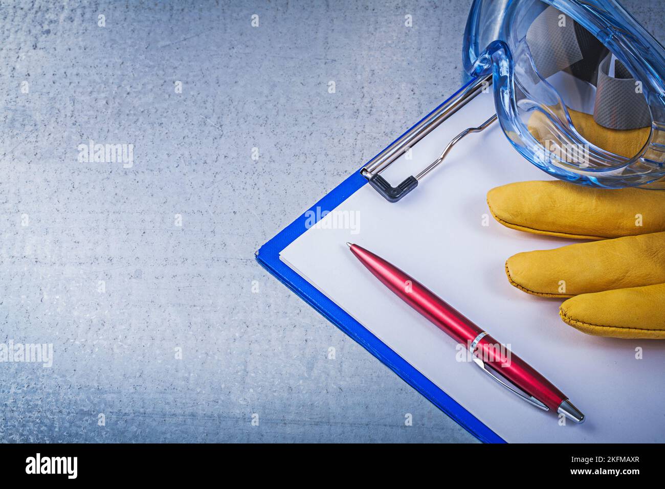 Plastic goggles leather gloves notepad pen on metallic background Stock ...