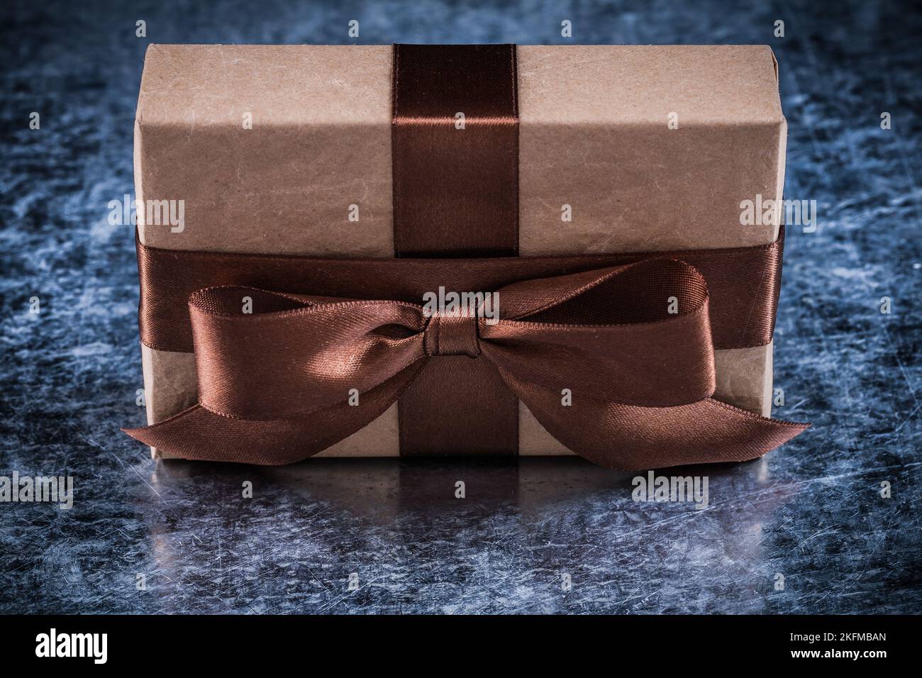 Present box with tied bow on metallic background holiday concept Stock ...