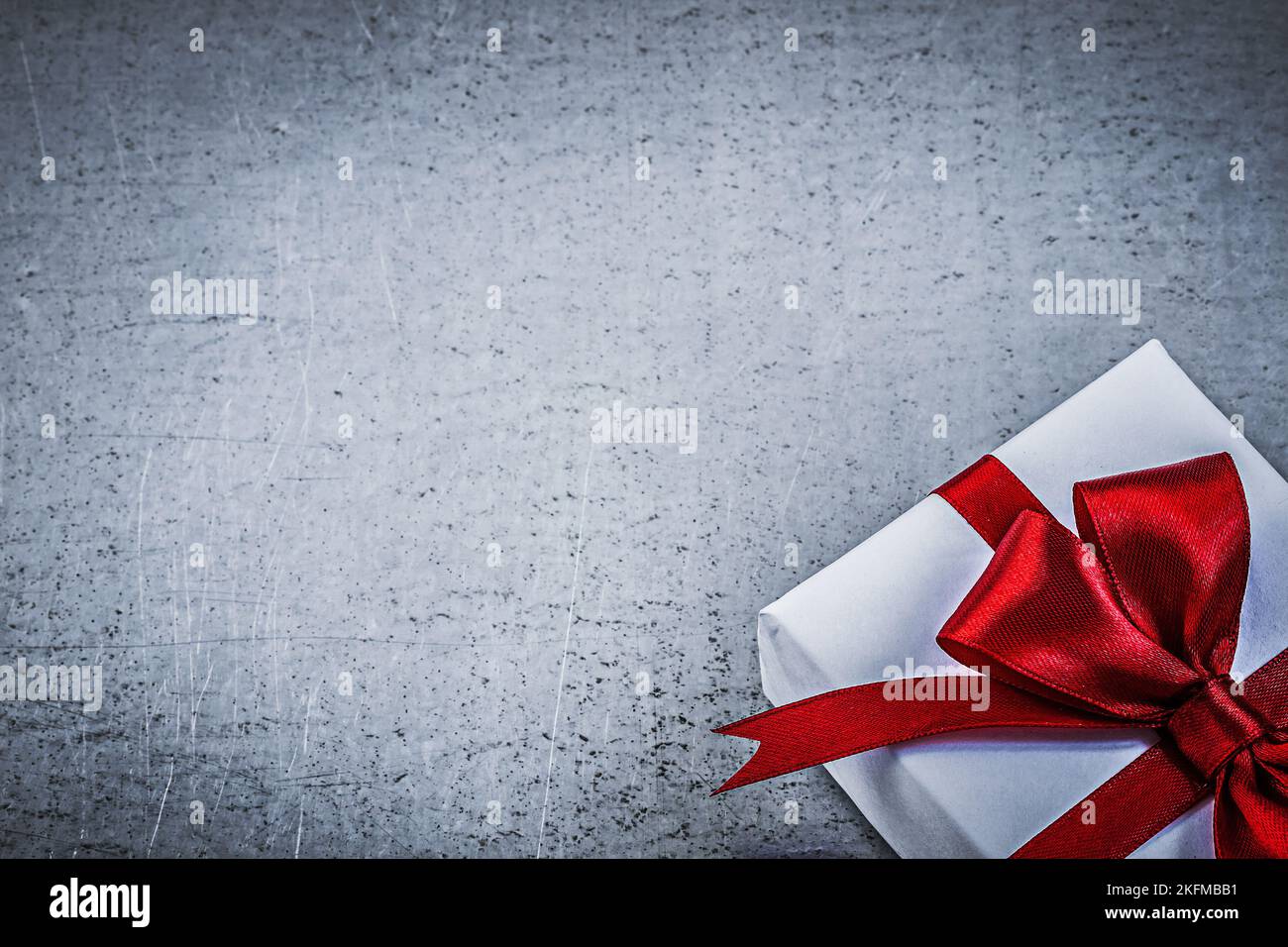 Present box with red ribbon on metallic background holidays concept ...