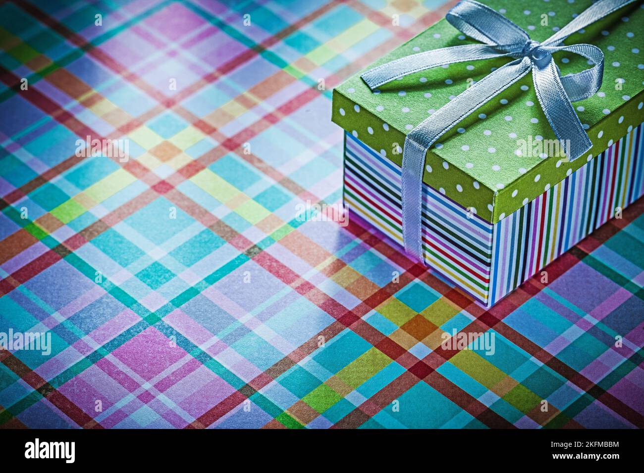 Present in cardboard box on checked table cloth holidays concept Stock ...