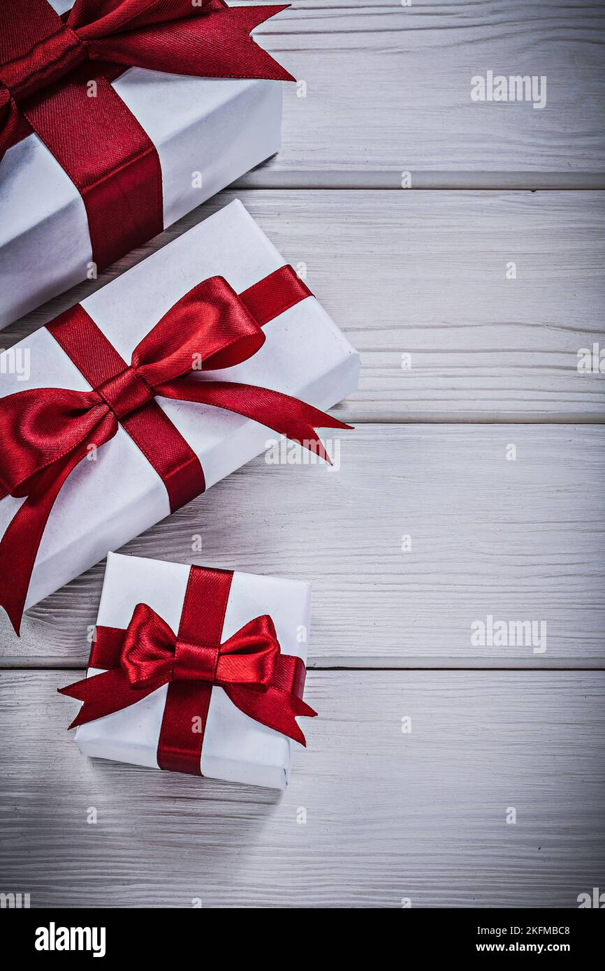 Present boxes with tied bows on wooden board holidays concept Stock ...