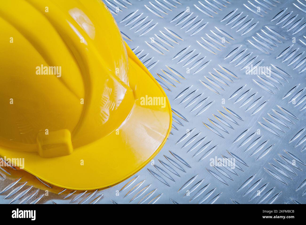 Protective building helmet on channeled metal background construction ...