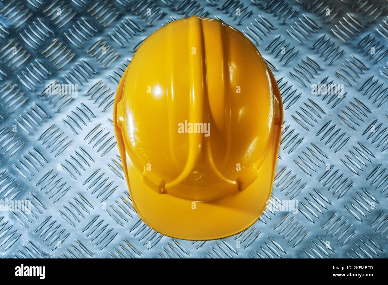 Protective building helmet on grooved metal sheet Stock Photo - Alamy