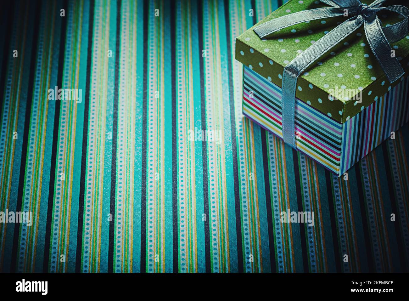 Present in cardboard box on striped background holidays concept Stock ...