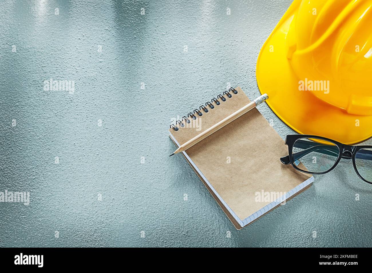 Protective cap glasses notepad pencil on concrete background Stock ...