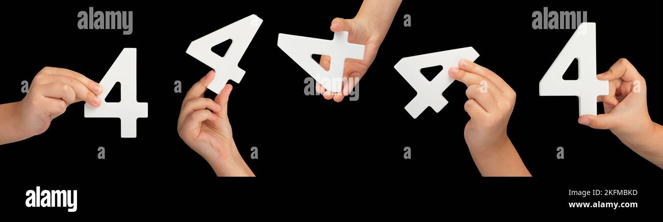 Number four in hand isolated on black background. Number four in a ...