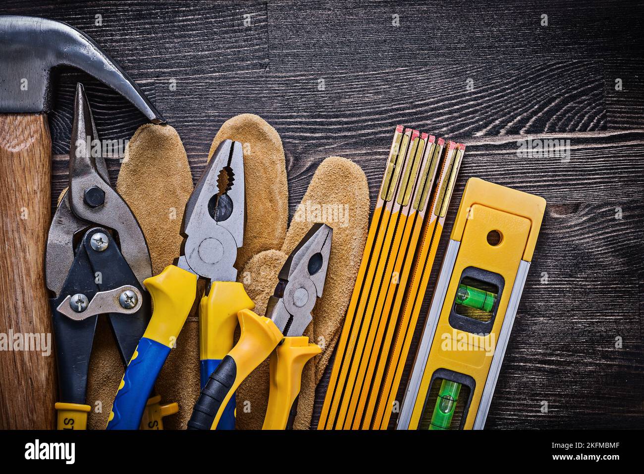 Protective gloves pliers tin snips wooden meter construction level ...