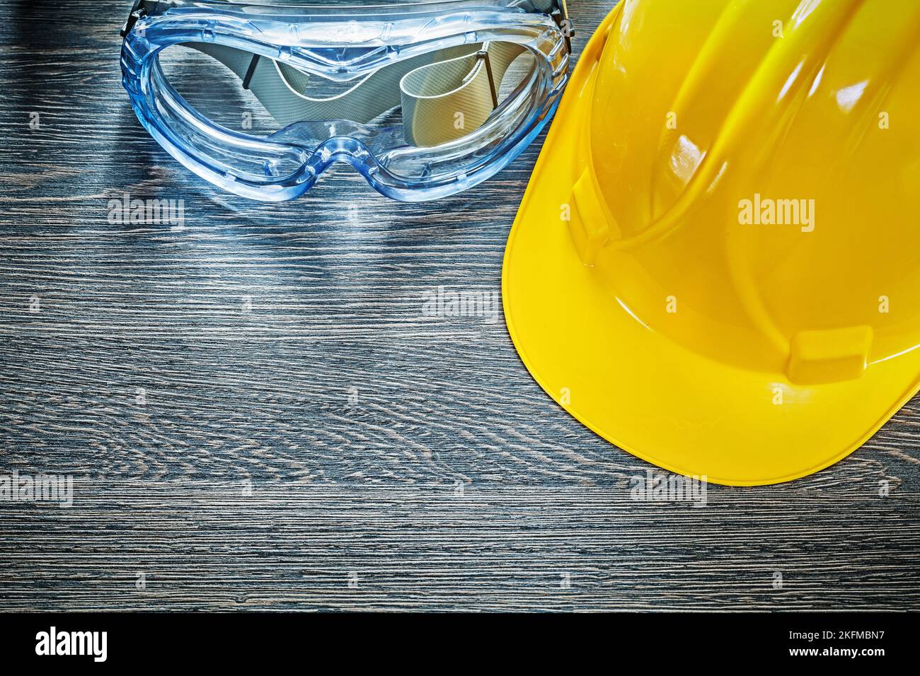 Protective goggles hard hat on wooden board Stock Photo - Alamy