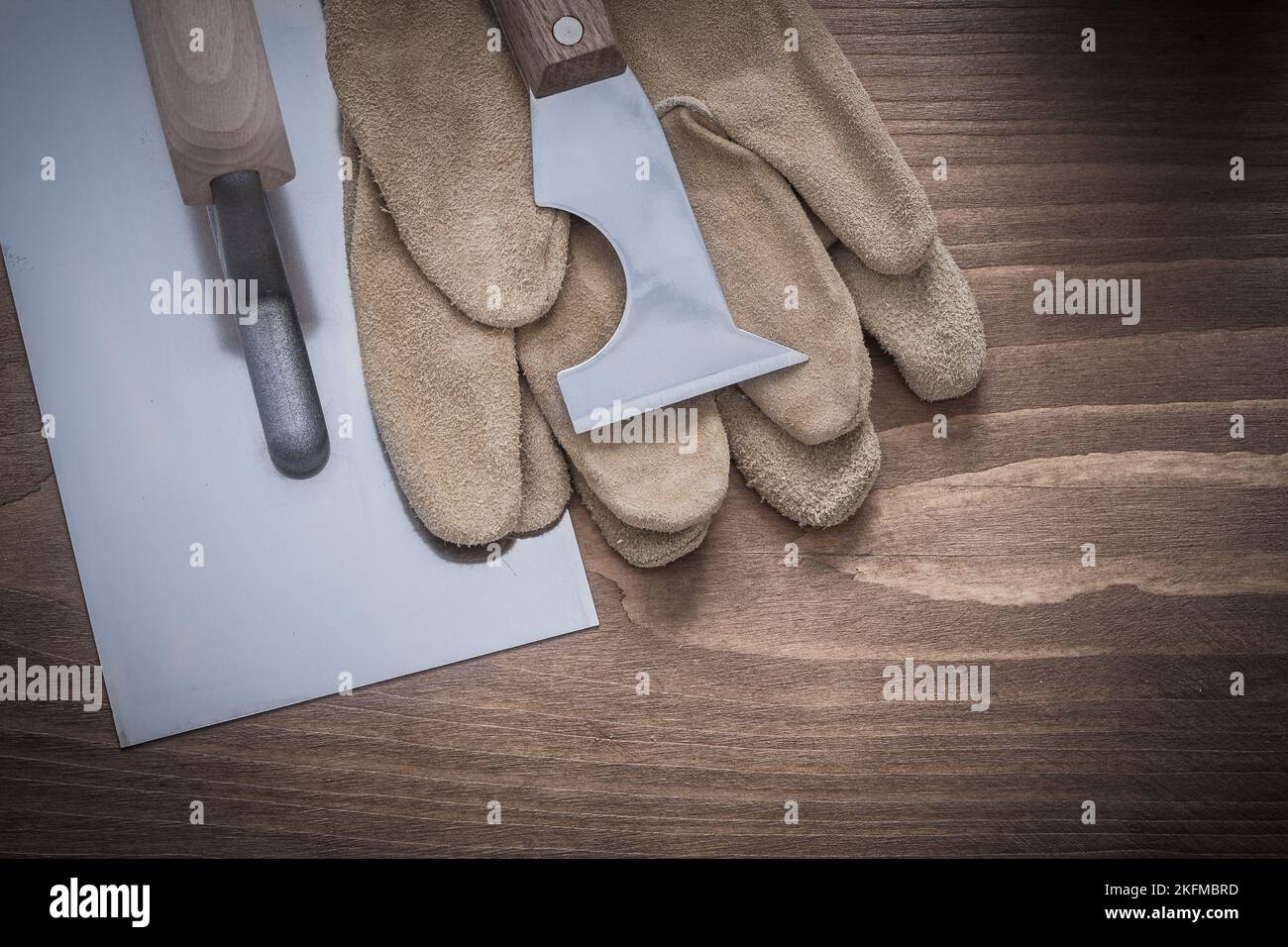 Putty knife plastering trowel and pair of leather working gloves Stock ...