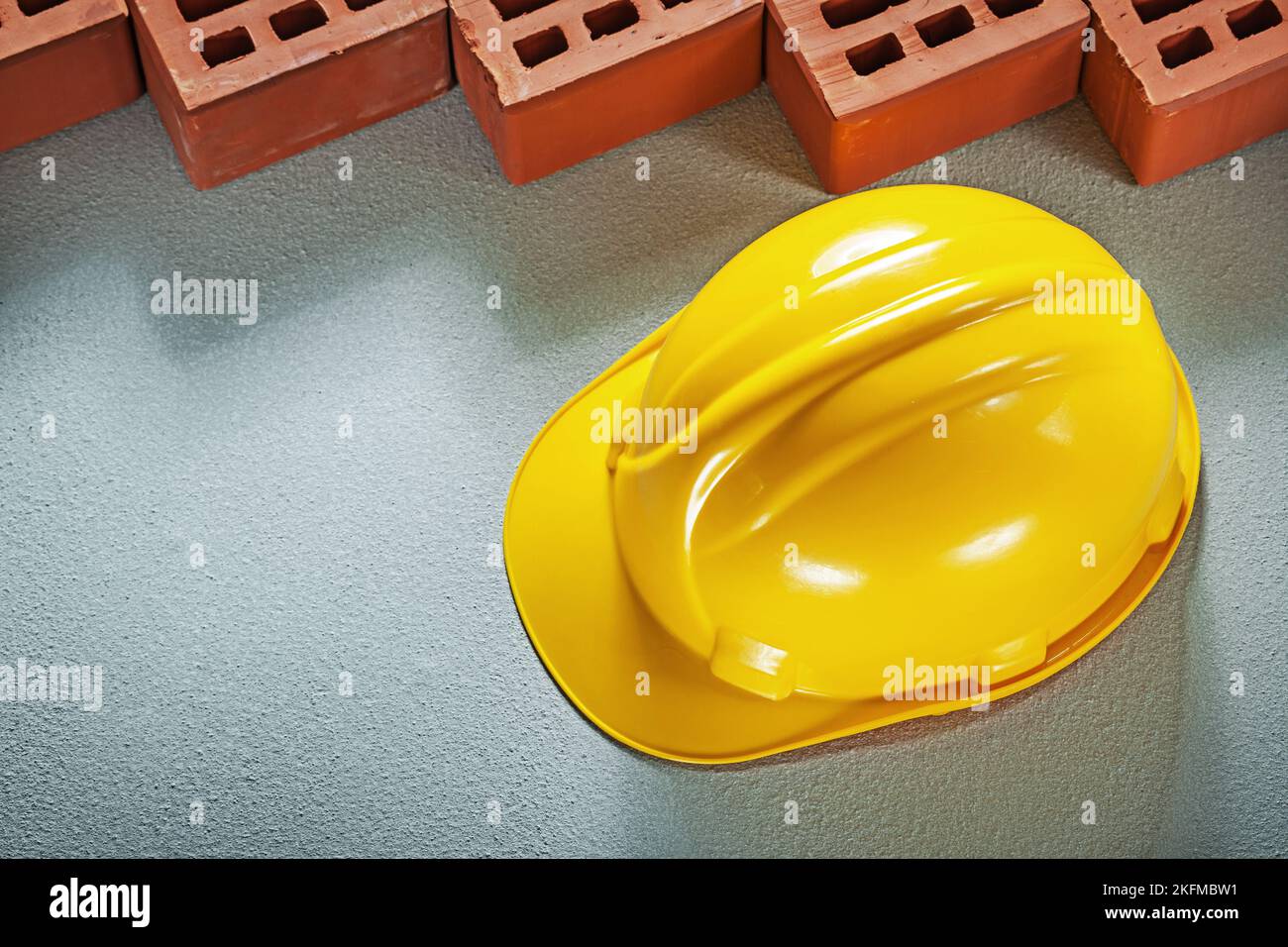 Red bricks building helmet on concrete surface construction concept ...