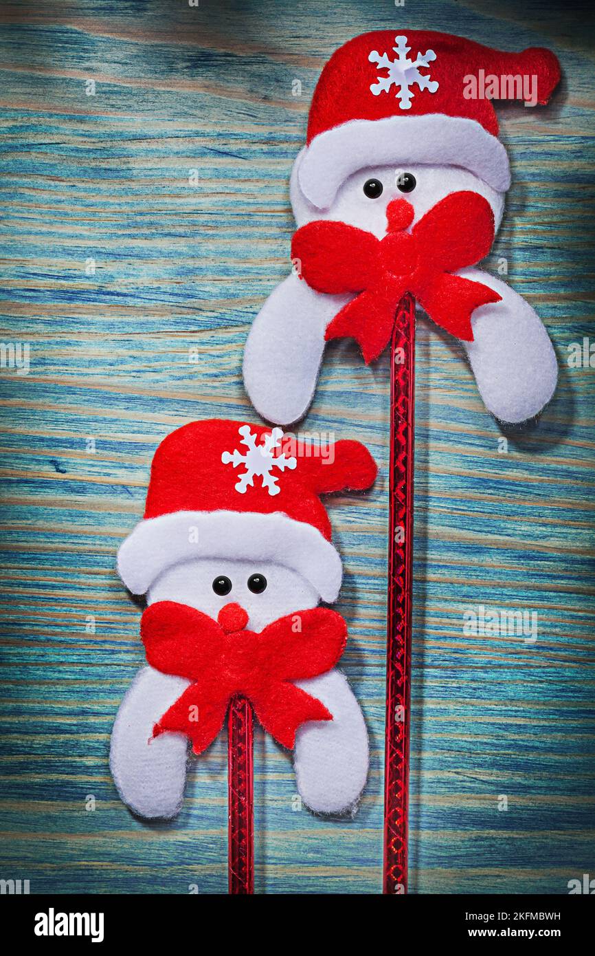 Red and white Father Christmas decorations on wooden background ...