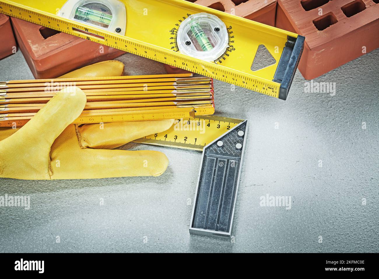 Red bricks construction level wooden meter square ruler on concrete ...