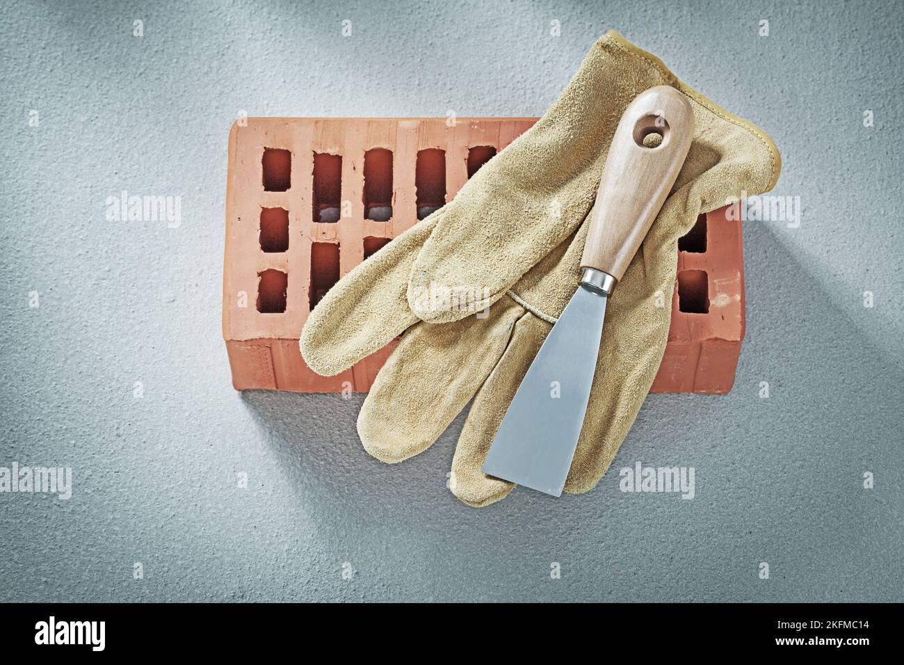 Red bricks safety gloves plastering trowel on concrete background ...