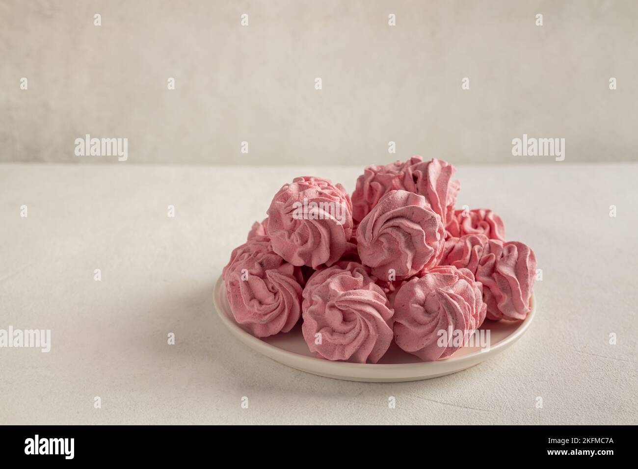 Delicious sweet zephyr and cherries on a light background, the concept ...