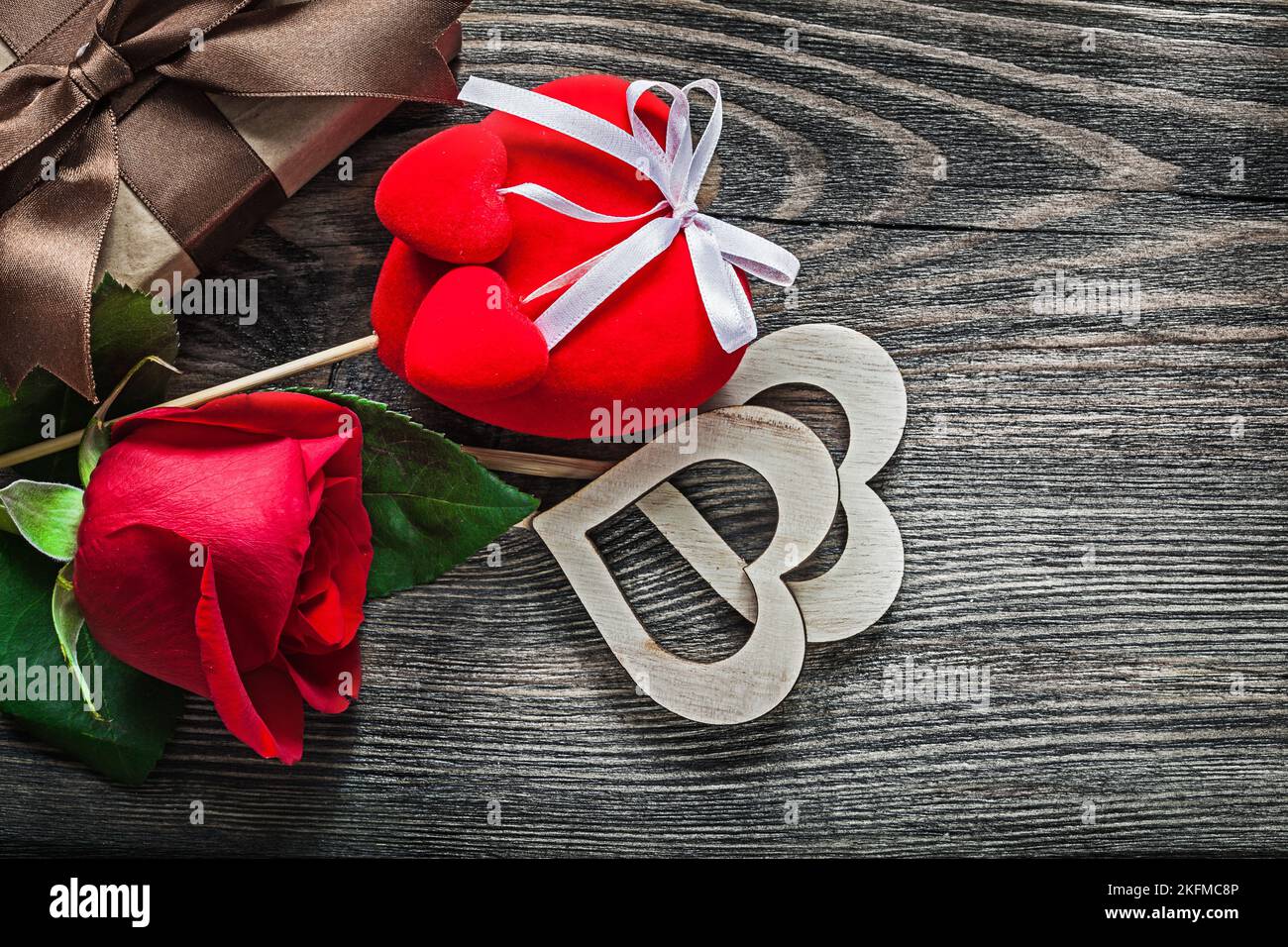 Red rose hearts packed gift box on wooden board celebrations concept ...