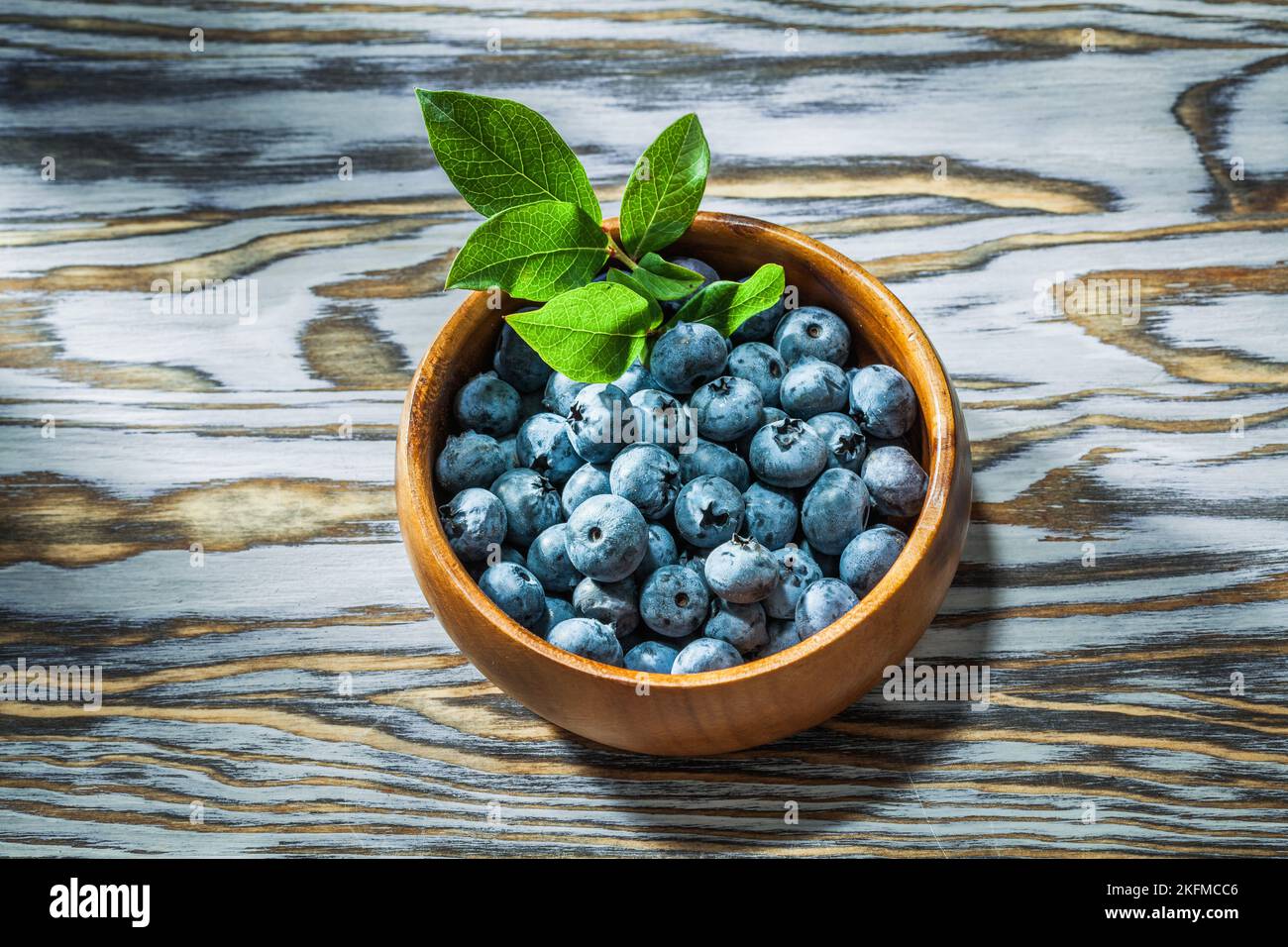 Ripe huckleberries in wooden bowl top view Stock Photo - Alamy
