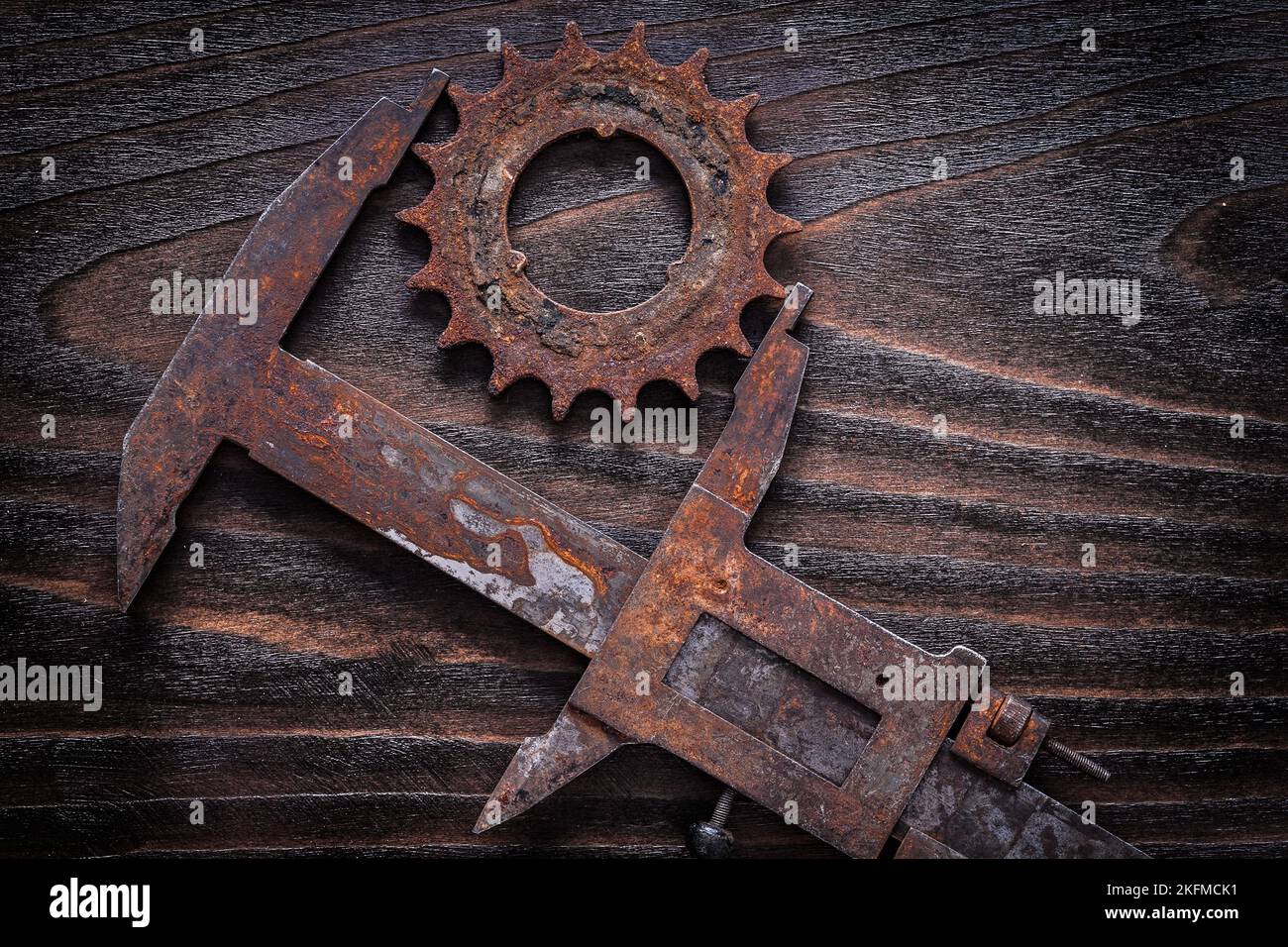 Rusted age-old measuring calipers with gear wheel on vintage dark ...