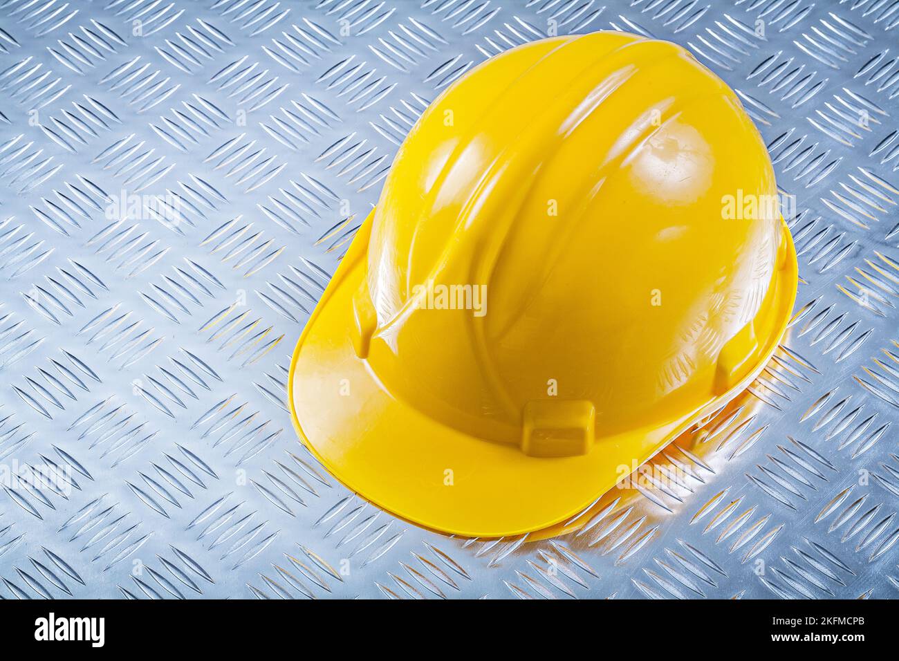 Safety building helmet on grooved metal plate construction concept ...