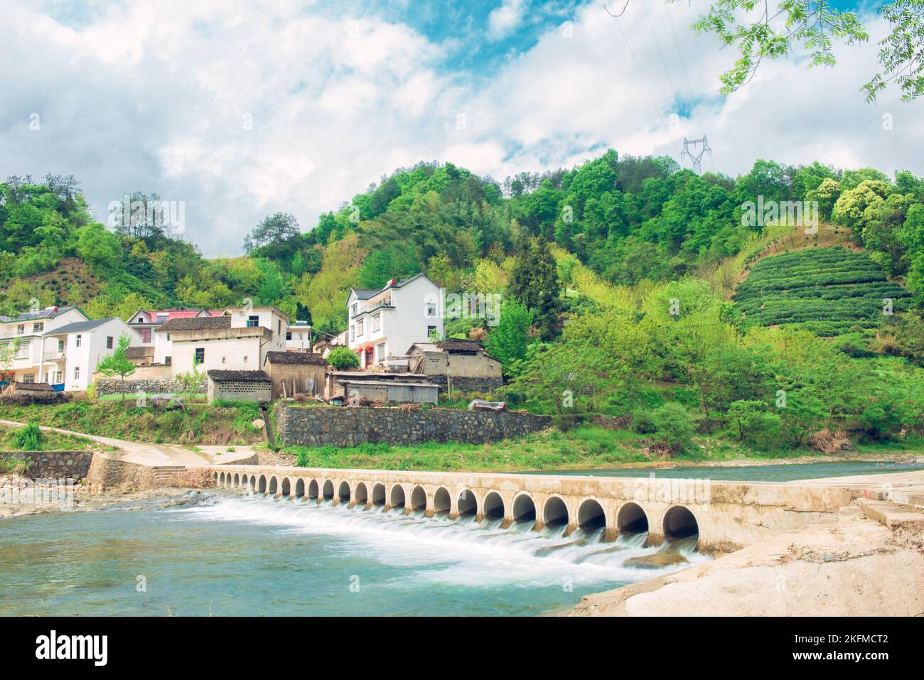 A beautiful shot of a stone bridge with the background of residential ...
