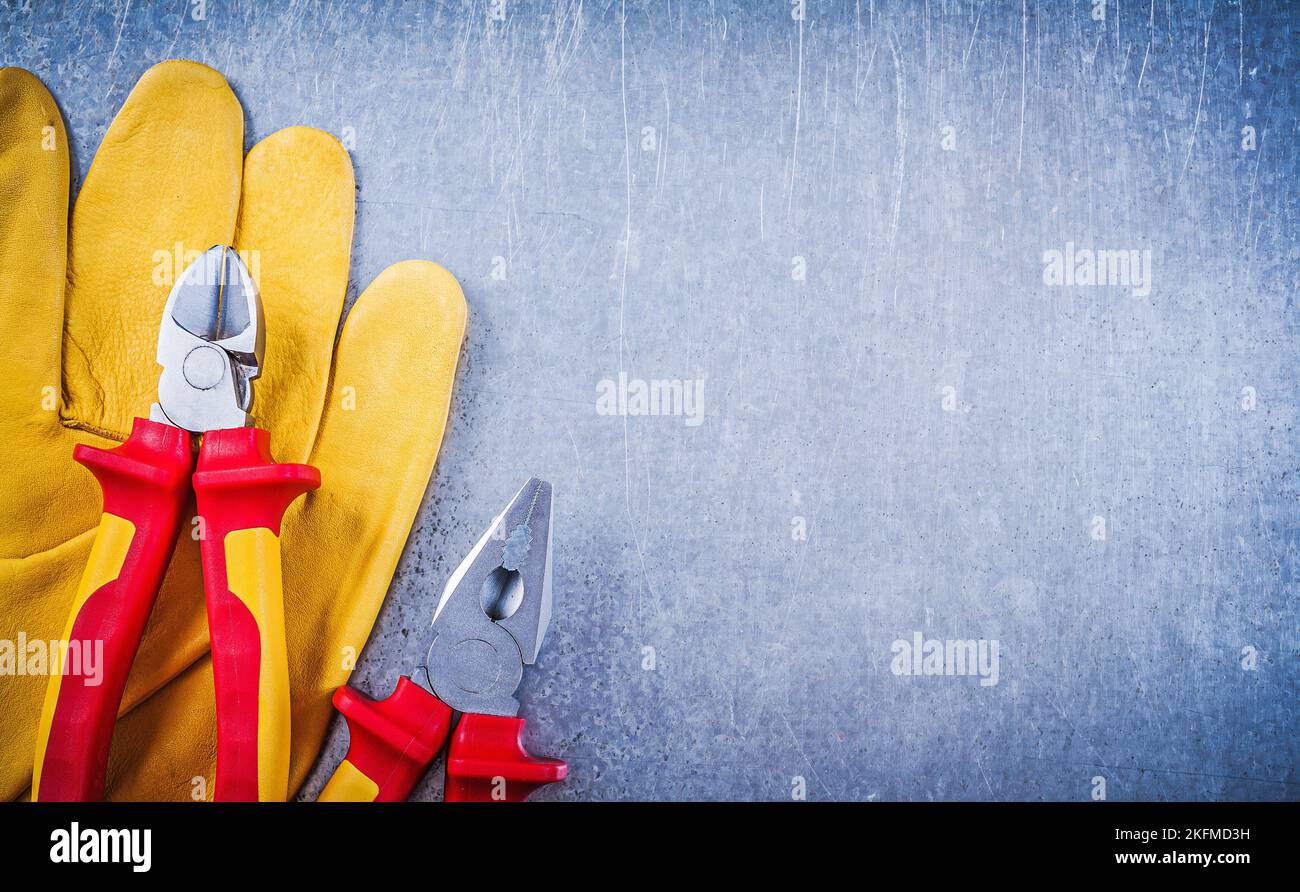 Safety gloves pliers wire-cutter on metallic background copyspace ...