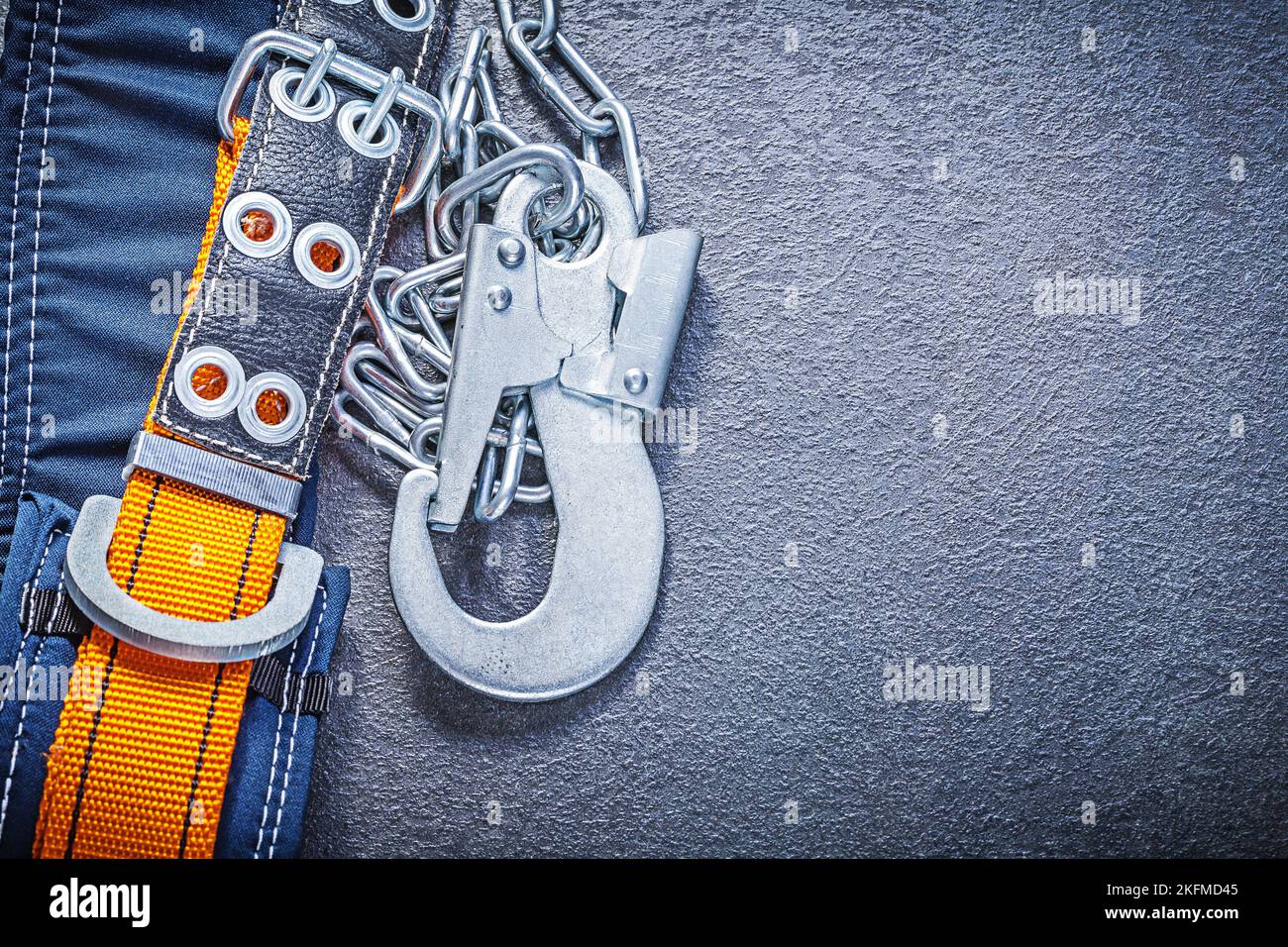Safety harness with metal chain carabiners on black background ...