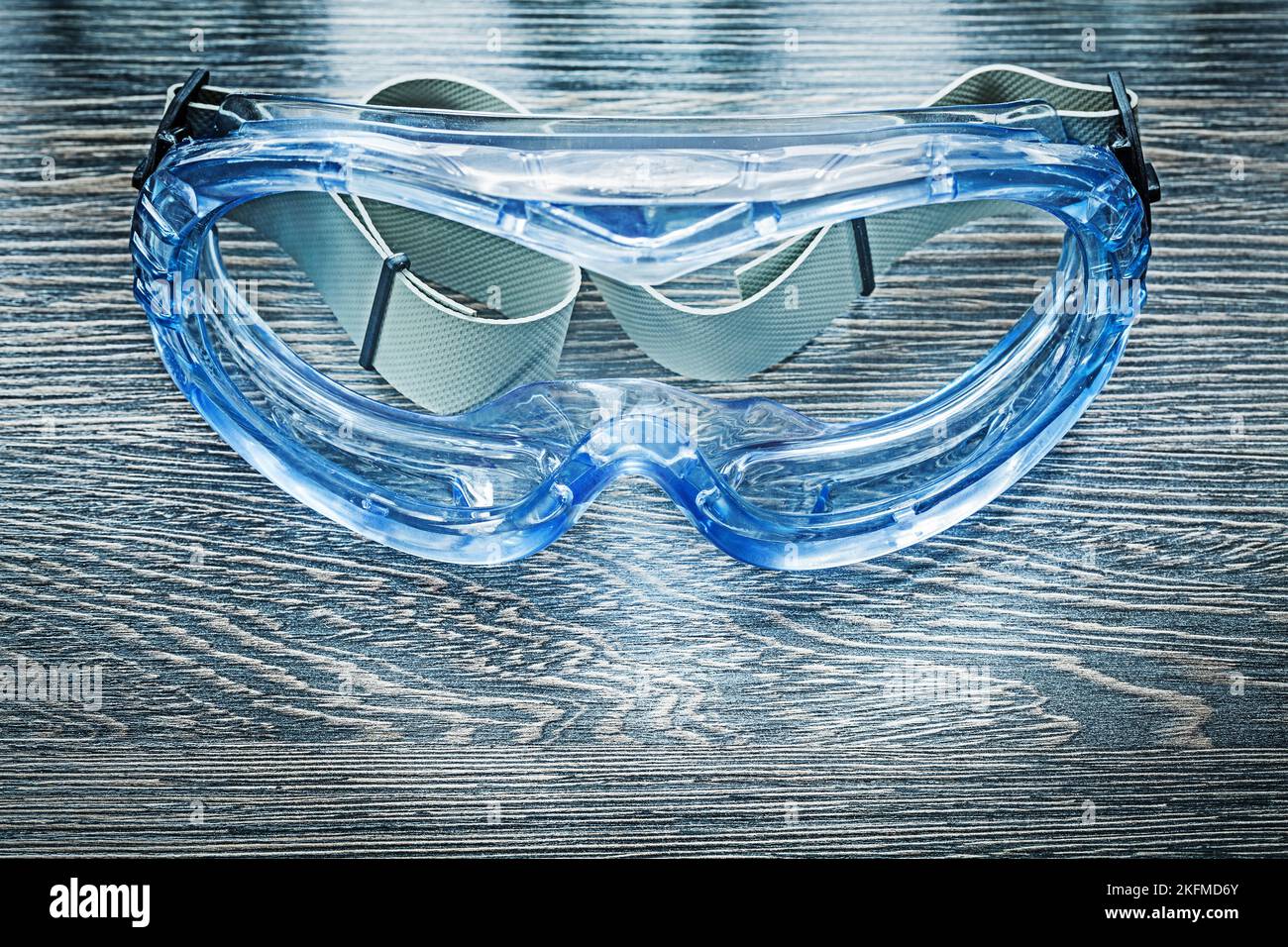 Safety plastic goggles on wooden board Stock Photo - Alamy