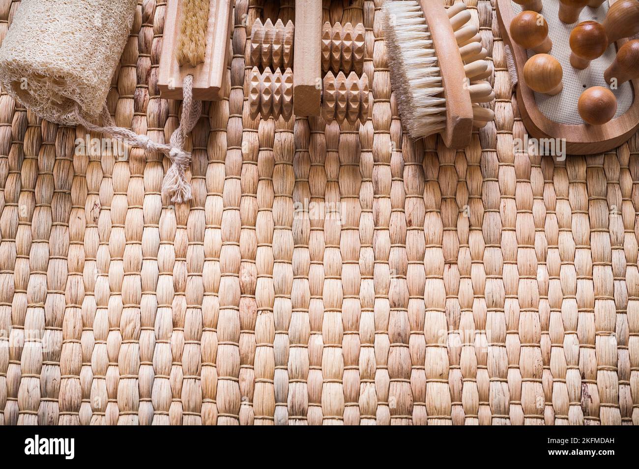 Scrubbing brush wooden massagers and loofah on wicker background ...