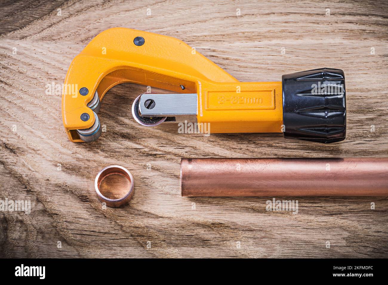 Set of copper water pipe scissors on wooden board plumbing brassware ...