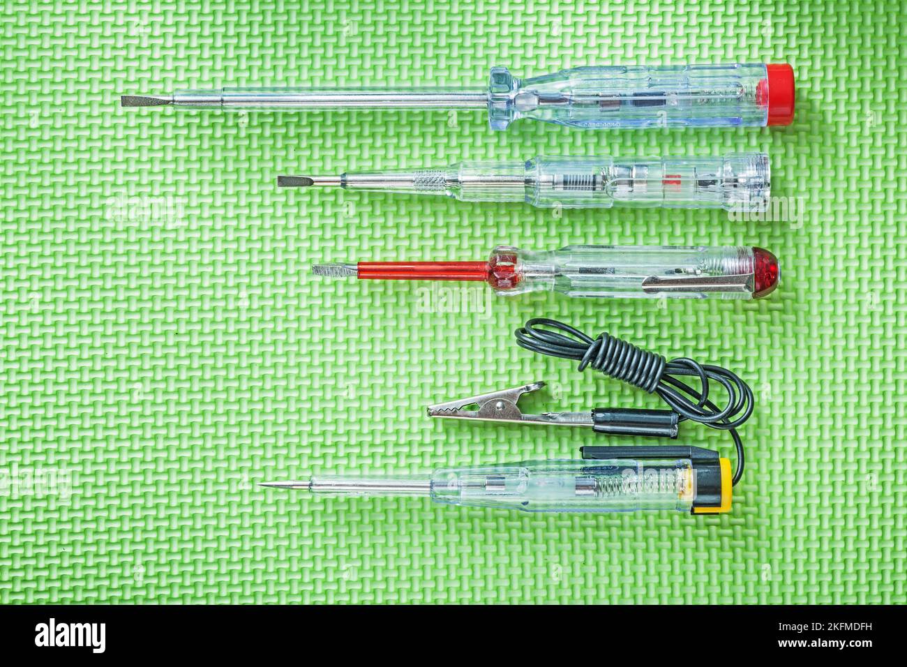 Set of electric testers on green background electricity concept Stock ...