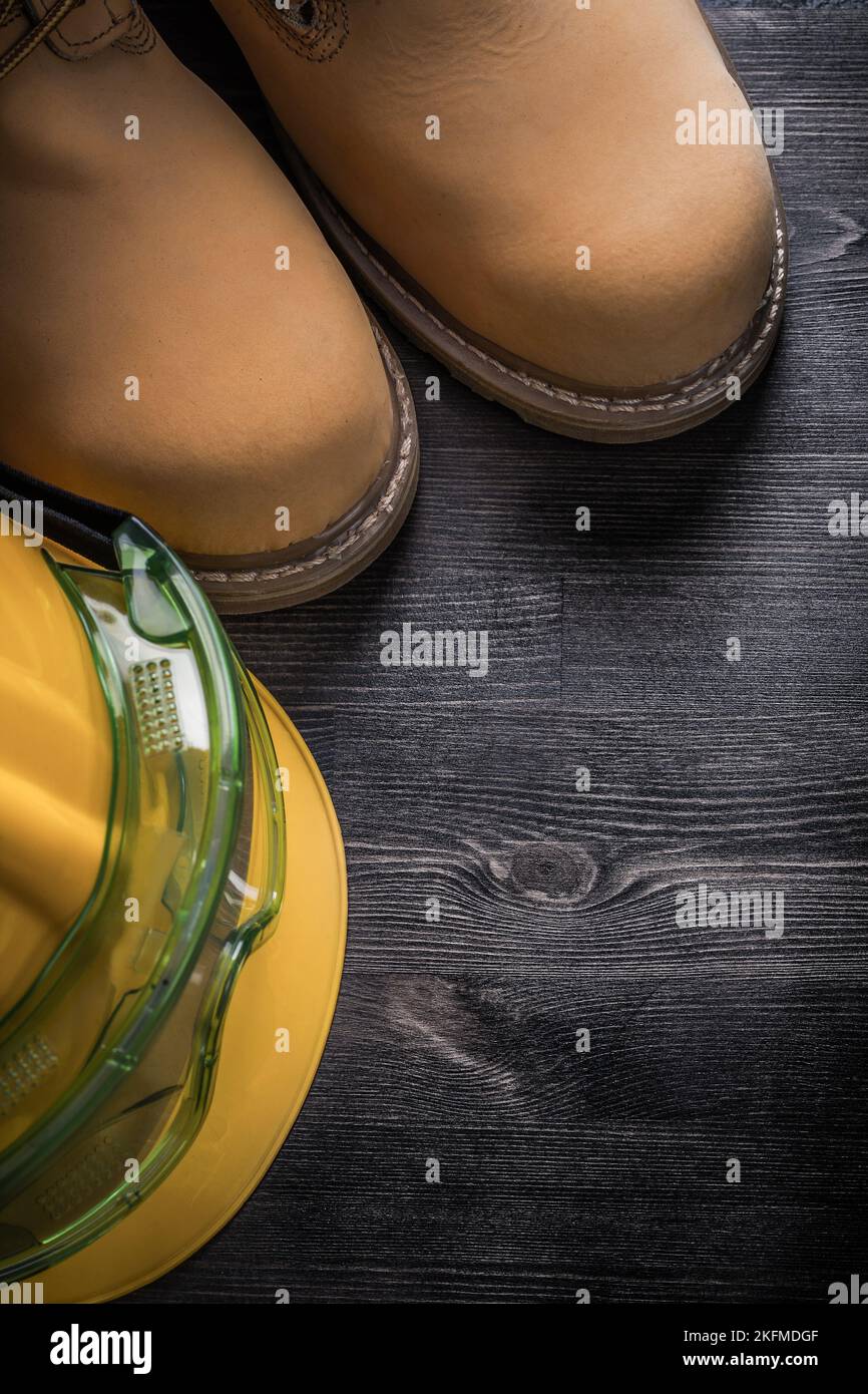 Set of goggles hard hat safety boots on wooden board Stock Photo - Alamy