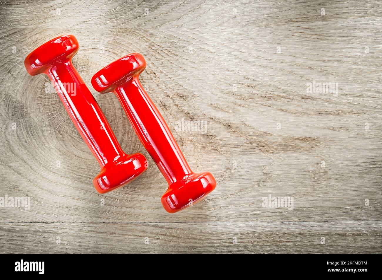 Set of red dumbbells on wood board top view fitness concept Stock Photo ...