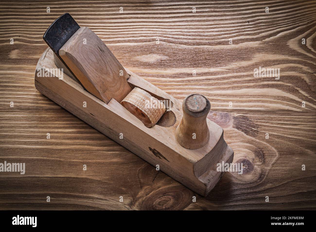 Shaving plane on vintage wooden board top view construction concept ...