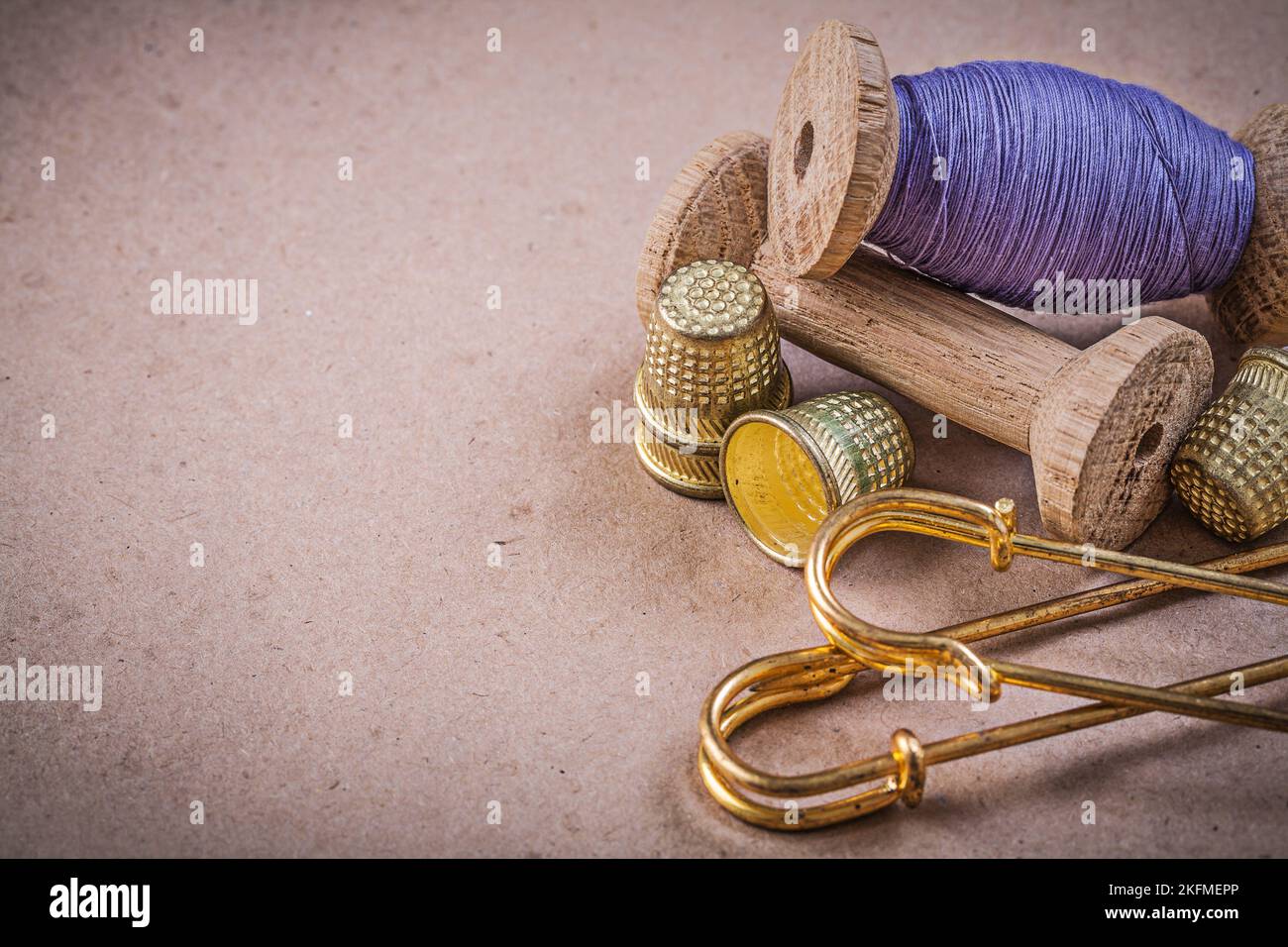 Spools of sewing threads thimbles clasp pins on vintage background ...