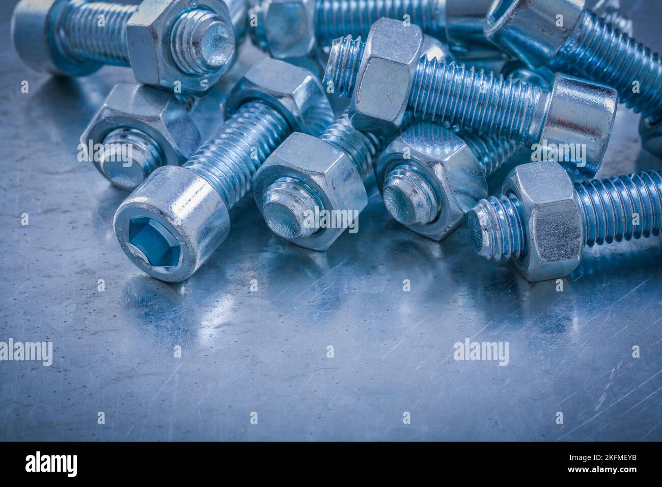 Stainless bolts and nuts on metallic background construction concept ...