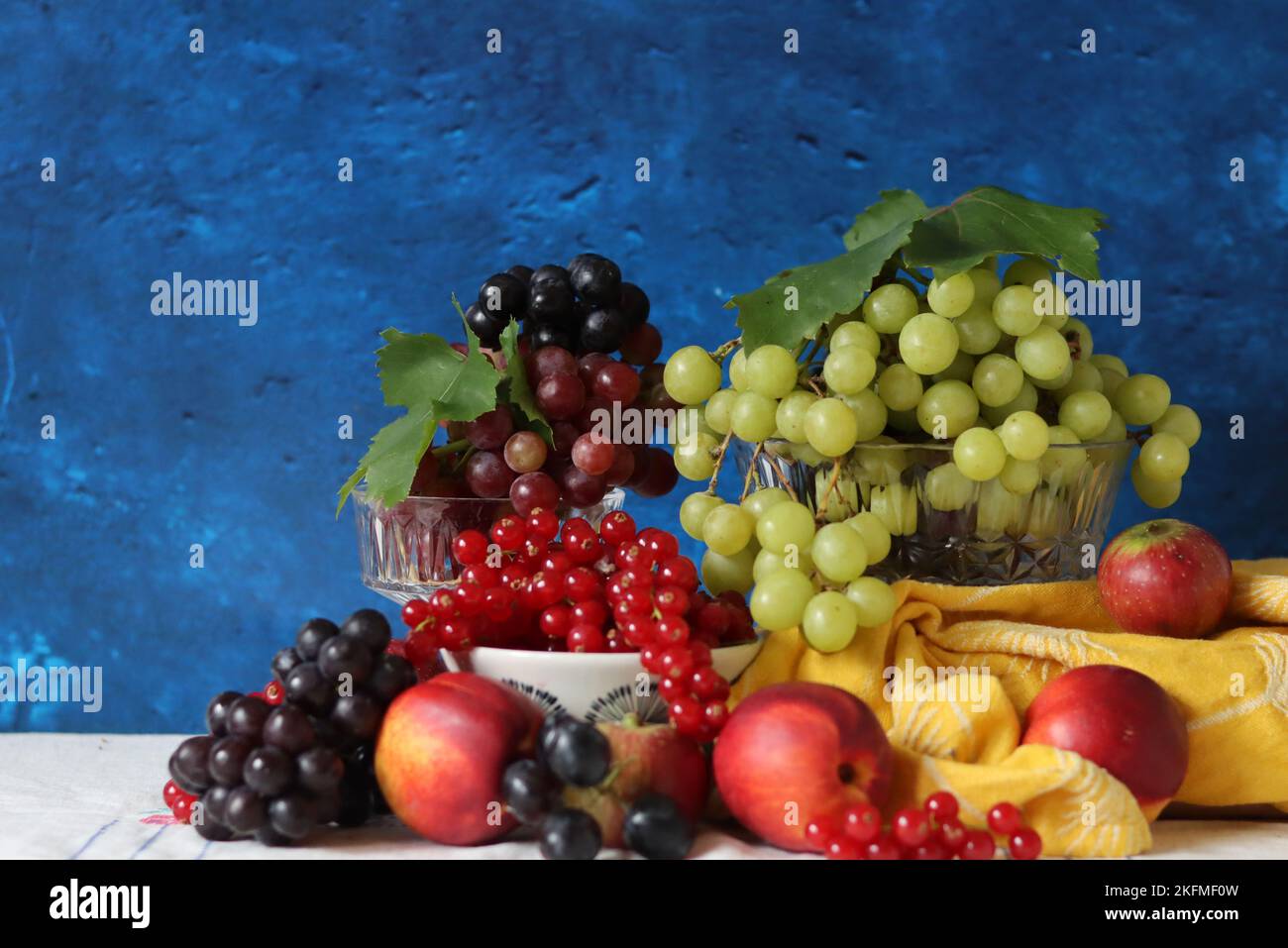 Colorful still life with seasonal fruit and berries on textured ...