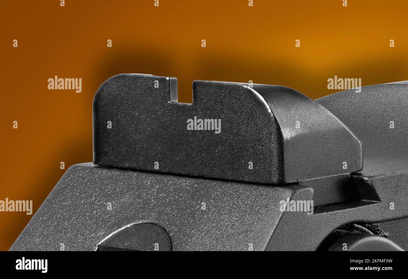 Rear sight on a pistol with brown background and shadow Stock Photo - Alamy